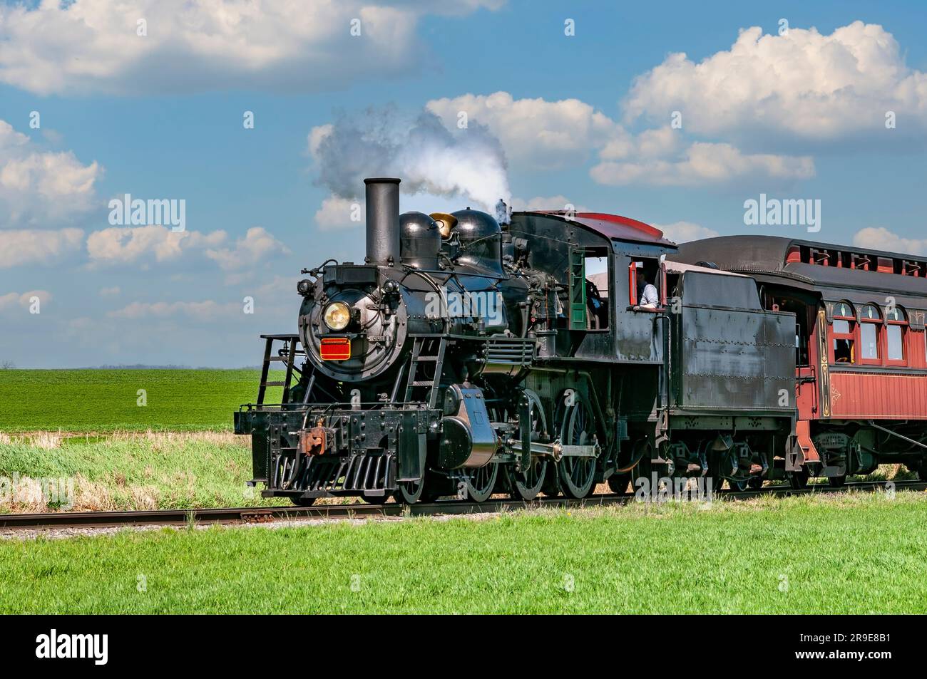 A View of a Restored Steam Passenger Train Traveling Thru Open Fields ...