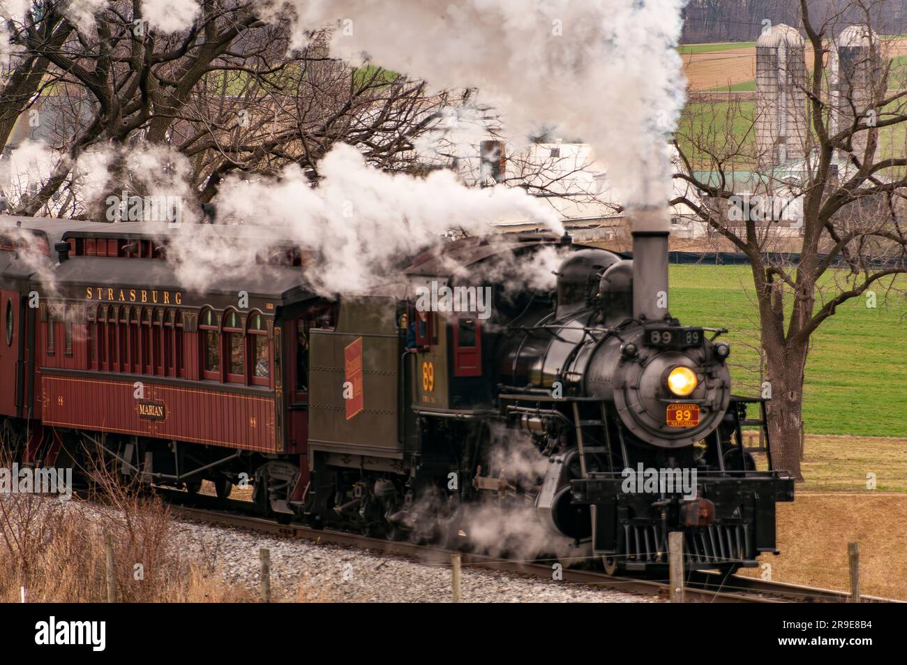 A View of a Restored Steam Passenger Train Approaching Out of a Wooded ...