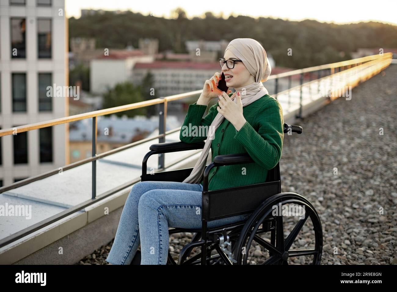 Easygoing muslim person in headscarf chatting on smartphone while ...