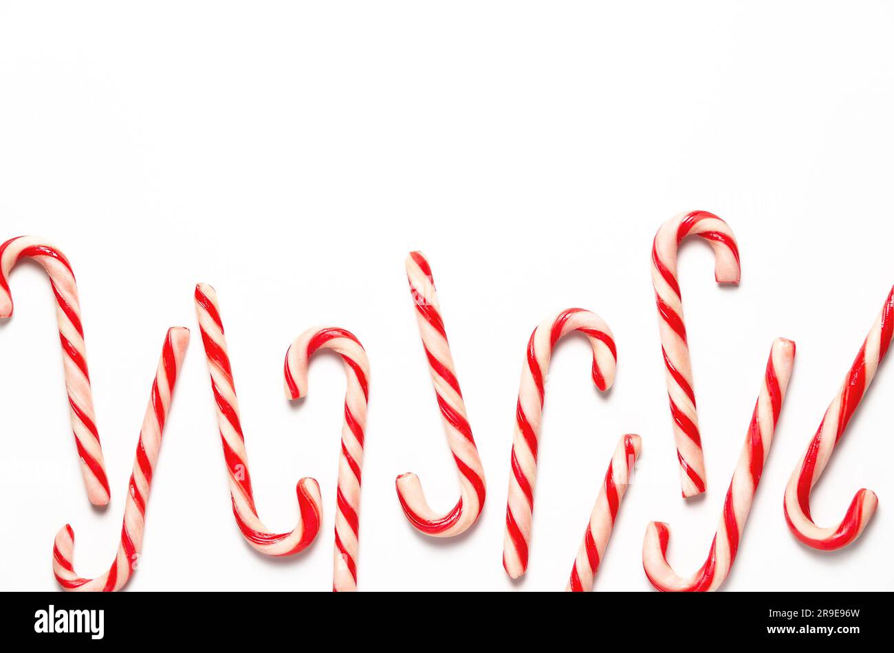 Christmas candy canes on white background. Copy space Stock Photo - Alamy