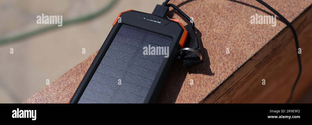 Solar charger lying outside and charging under sun rays closeup Stock ...