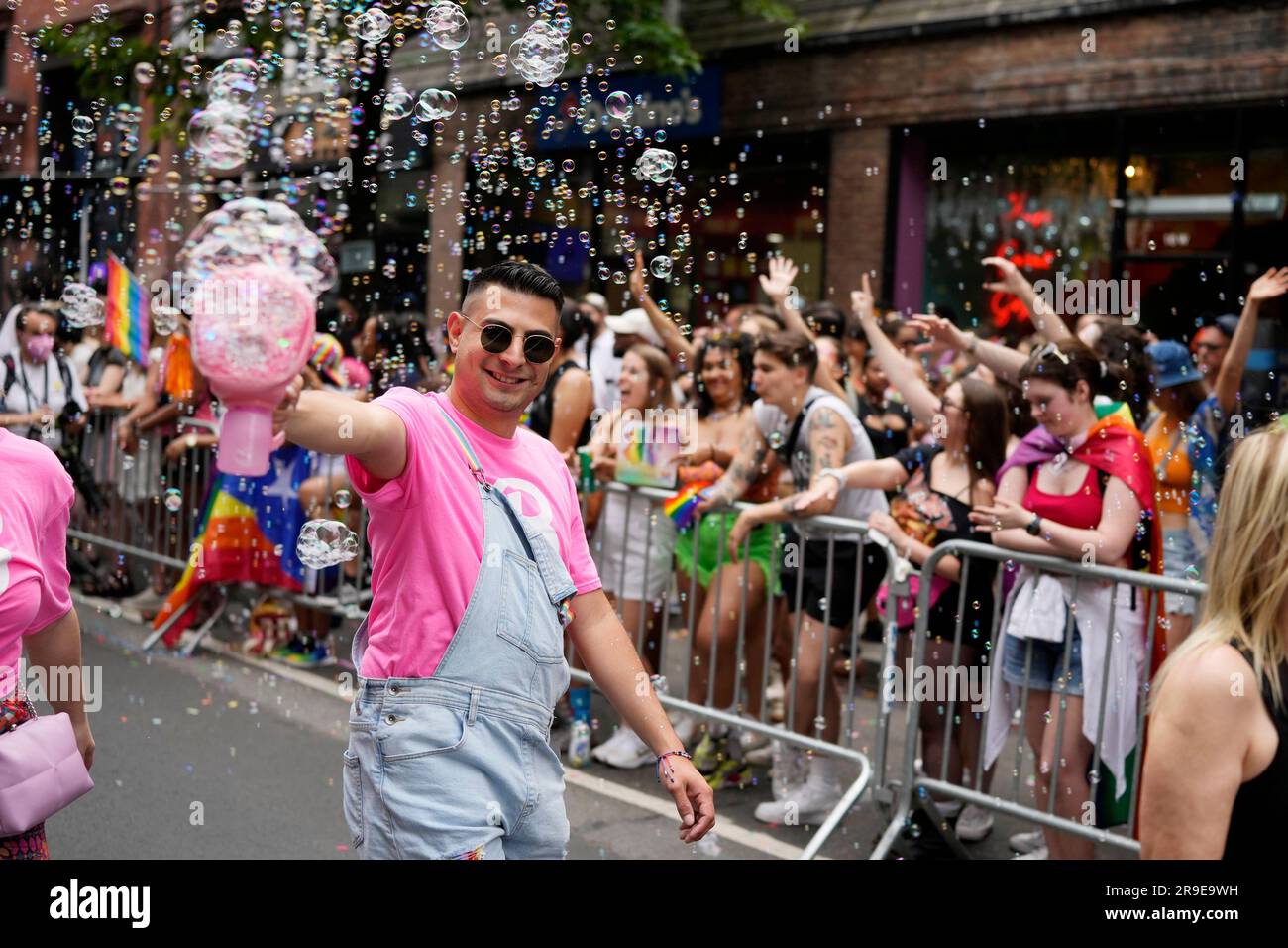 A paradegoers promoting the upcoming "Barbie," movie walks in the NYC ...