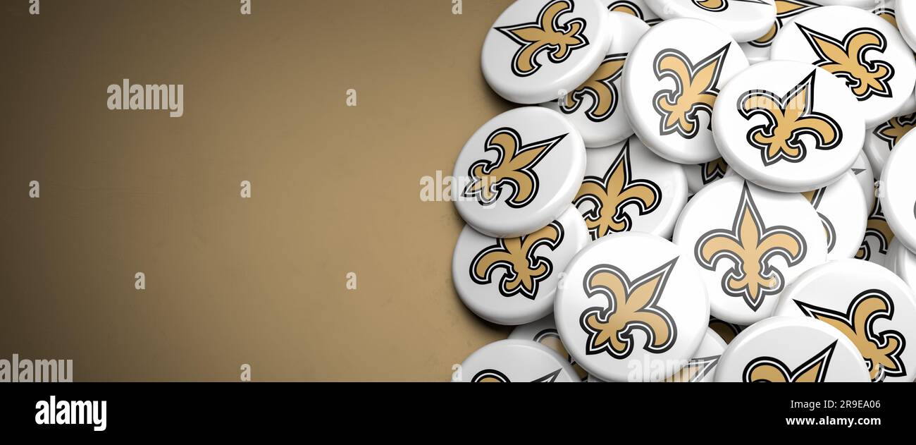 Logos of the American Football Team New Orleans Saints on a heap on a ...