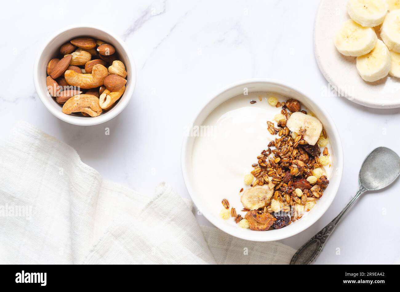 Healthy breakfast with yogurt, granola and nuts on white background ...
