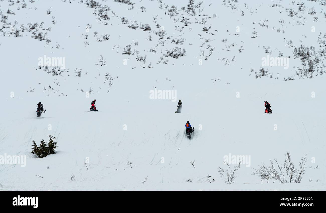 Snow mobiles on the side of a snow covered mountain at Turnagain Pass ...
