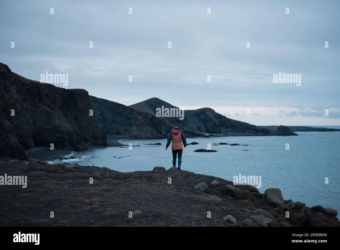 Landscape image with a dramatic view of a black sand beach and the ...
