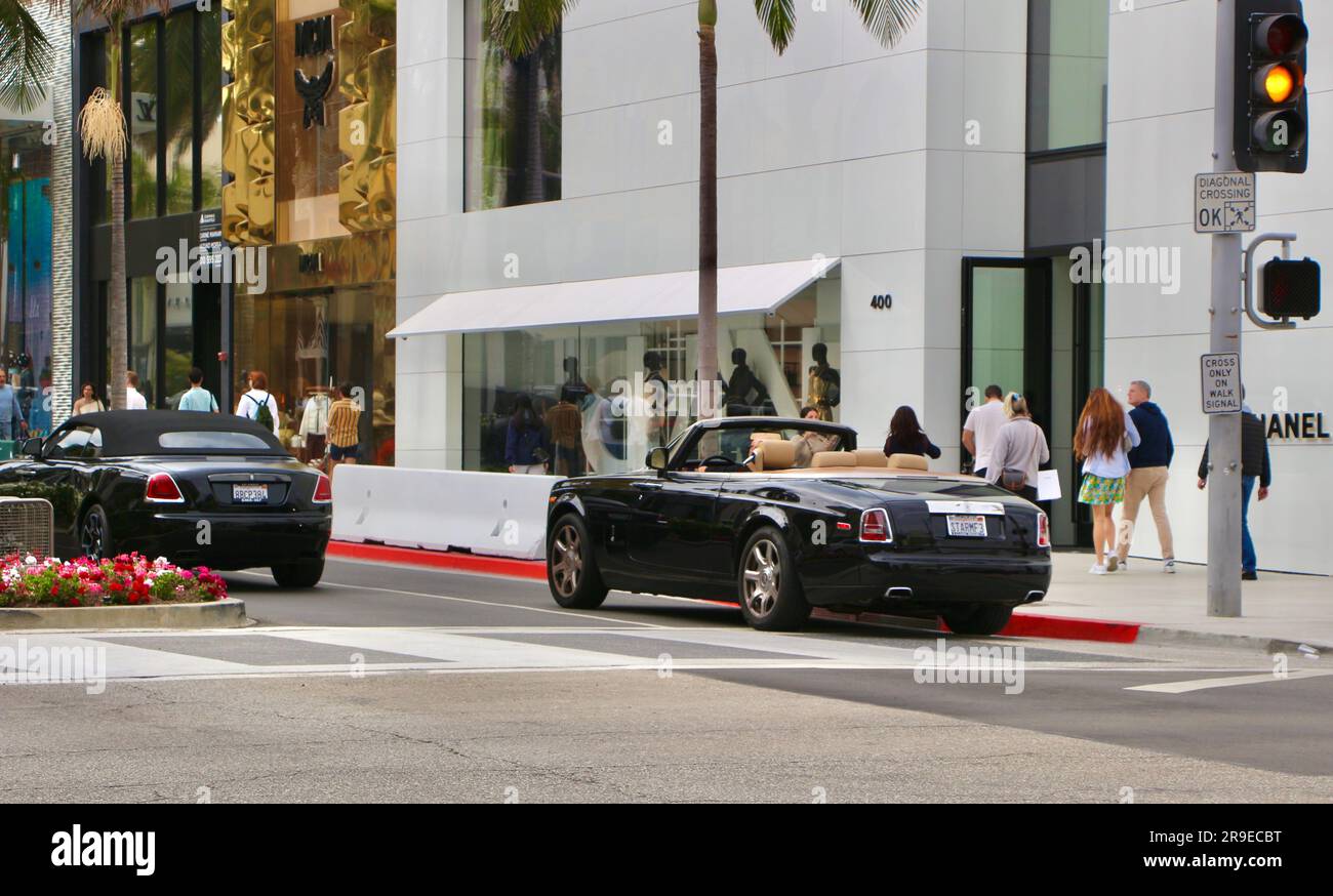 Rear view of two black convertible Rolls Royce Dawn cars Rodeo Drive ...