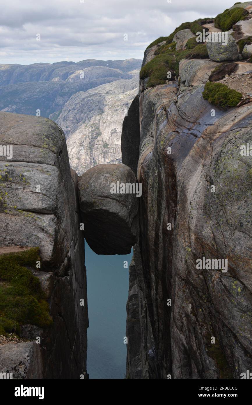 A scenic view of a rock formation cut in two by a narrow divide ...