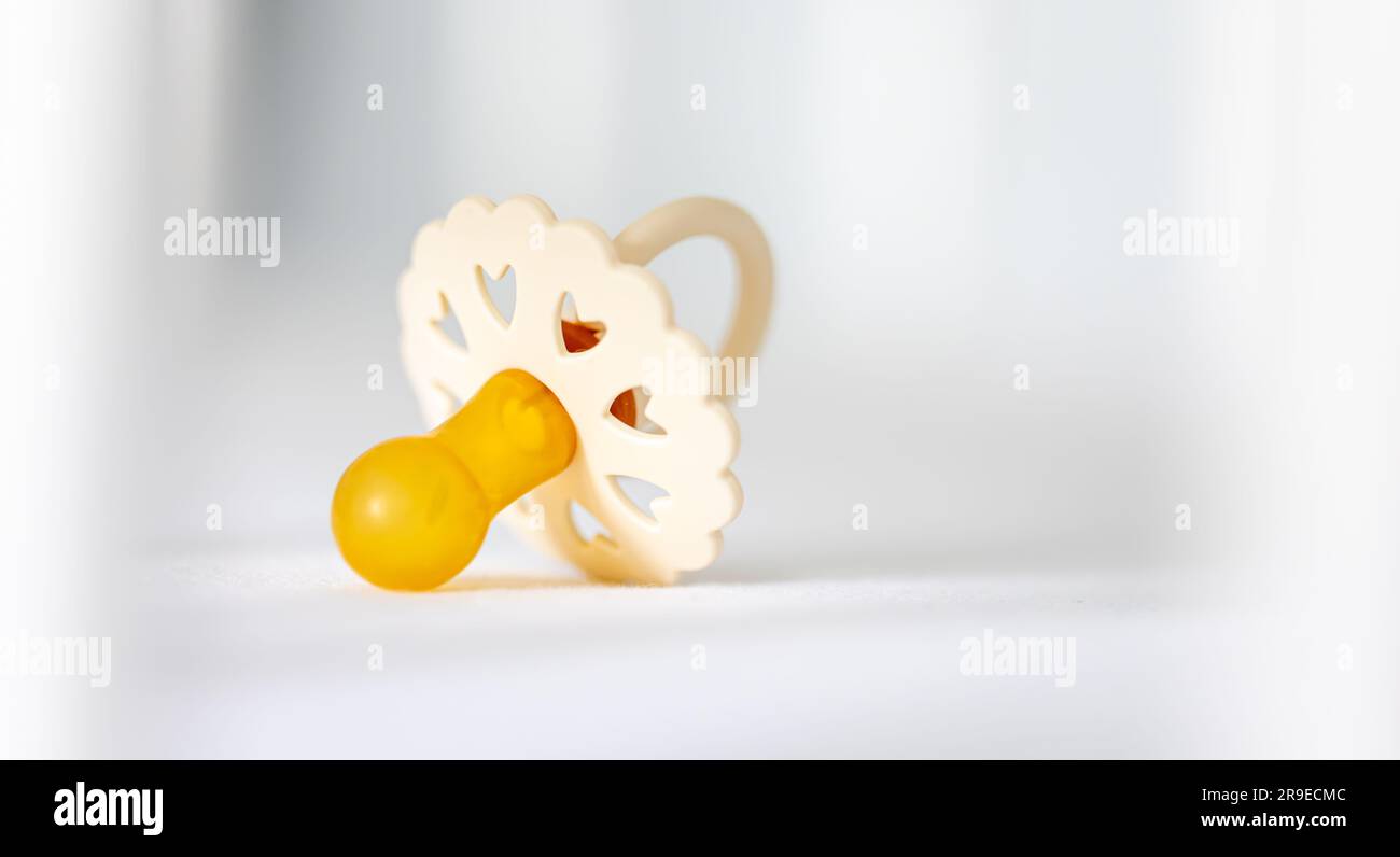Baby's pacifier on a blurred white background Stock Photo - Alamy