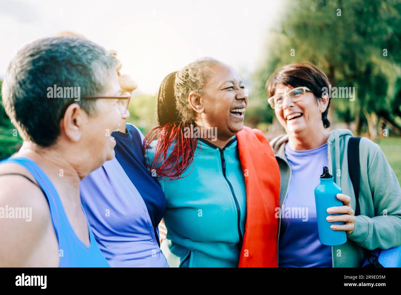 Senior sport people having fun after exercising in yoga class outdoor ...