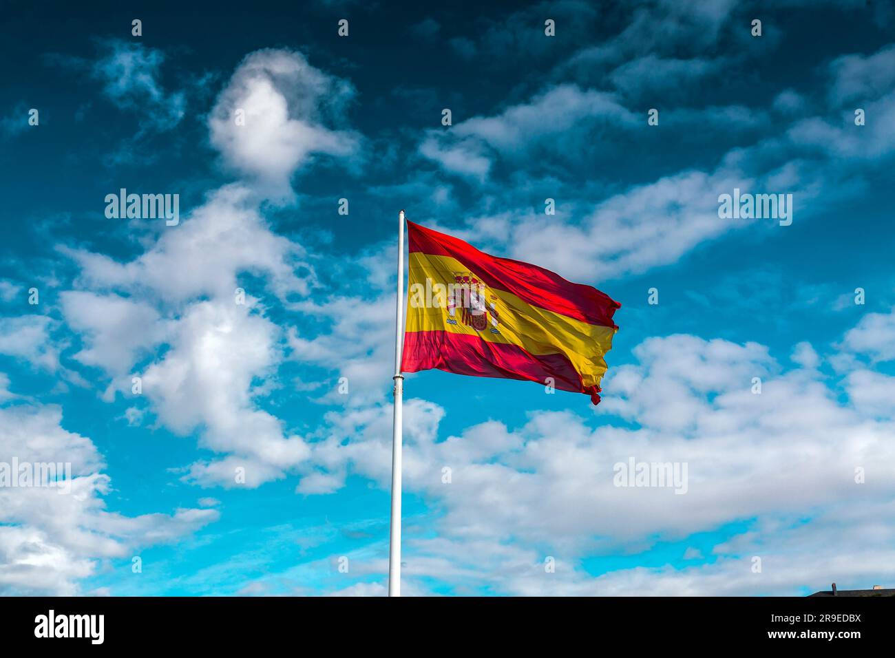 Spanish flag waving in the clear blue sky Stock Photo - Alamy