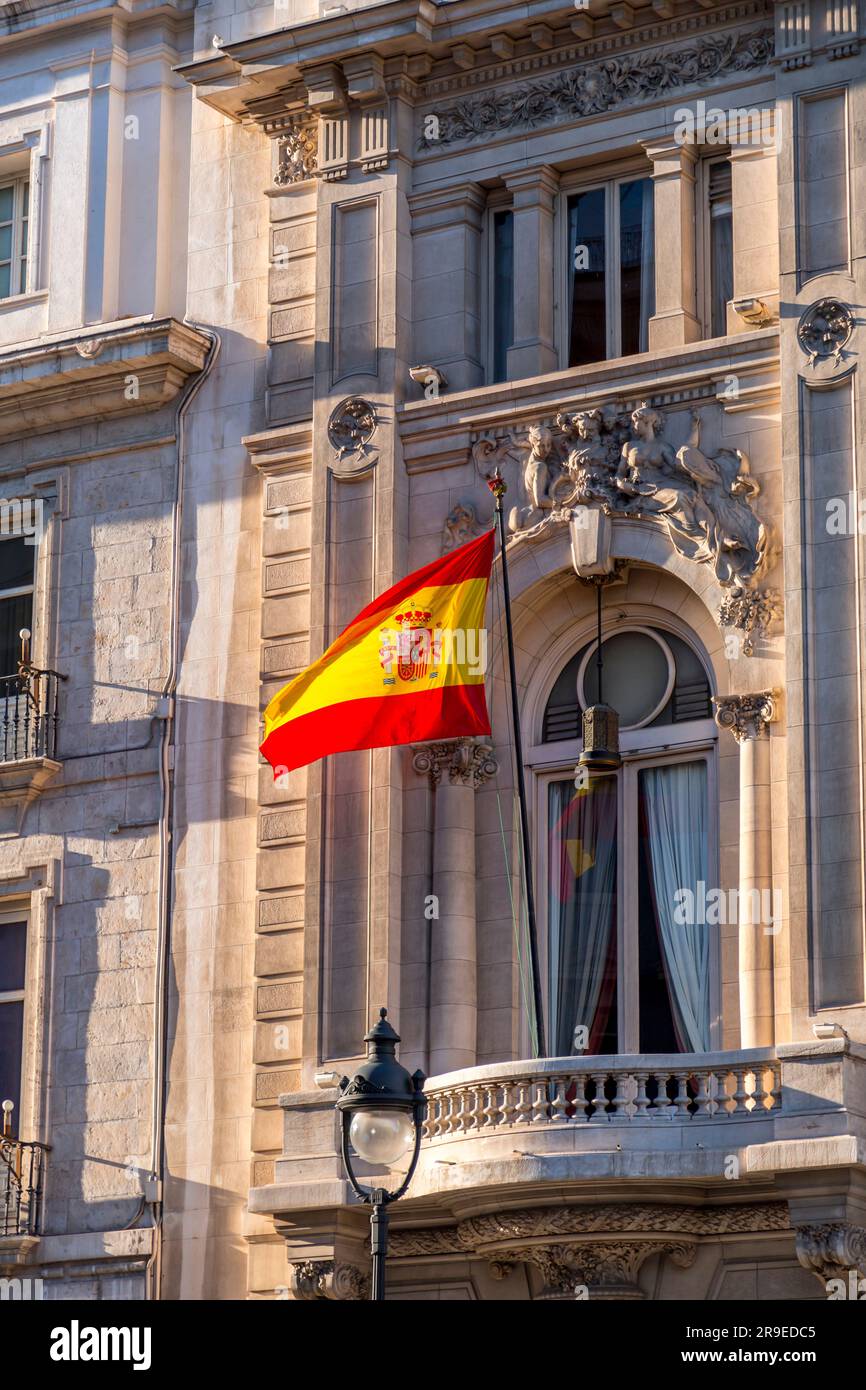 Spanish flag waving on a pole in a balcony of a classic building in ...