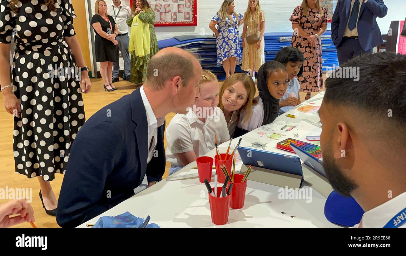 The Prince of Wales and charity advocate Gerri Horner (centre) speak to ...