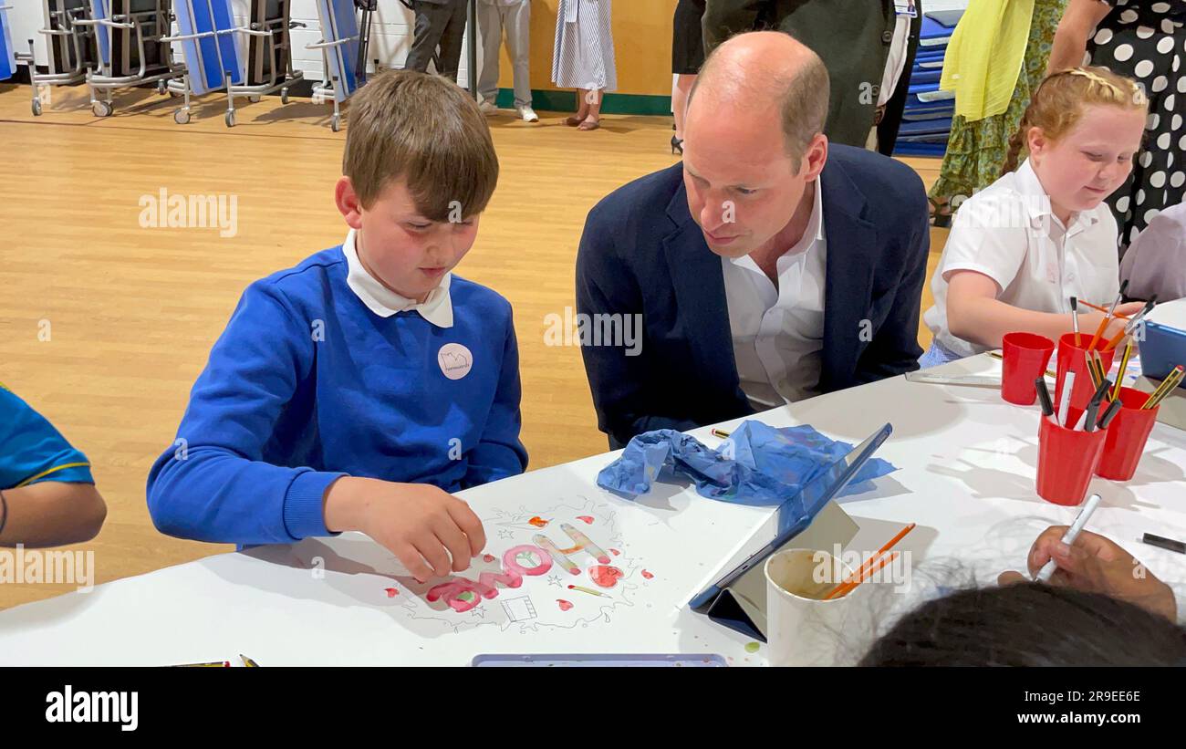 The Prince of Wales speaks to school children during a visit to Maindee Primary School in ...