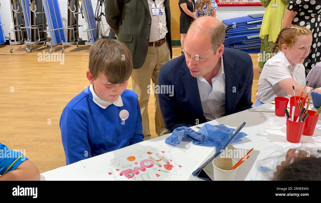 The Prince of Wales speaks to school children during a visit to Maindee ...