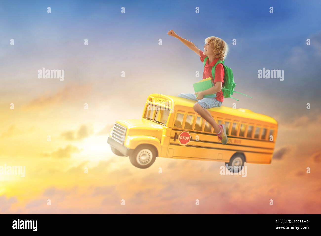 Child going back to school. Boy flying on school bus. Imagination and ...