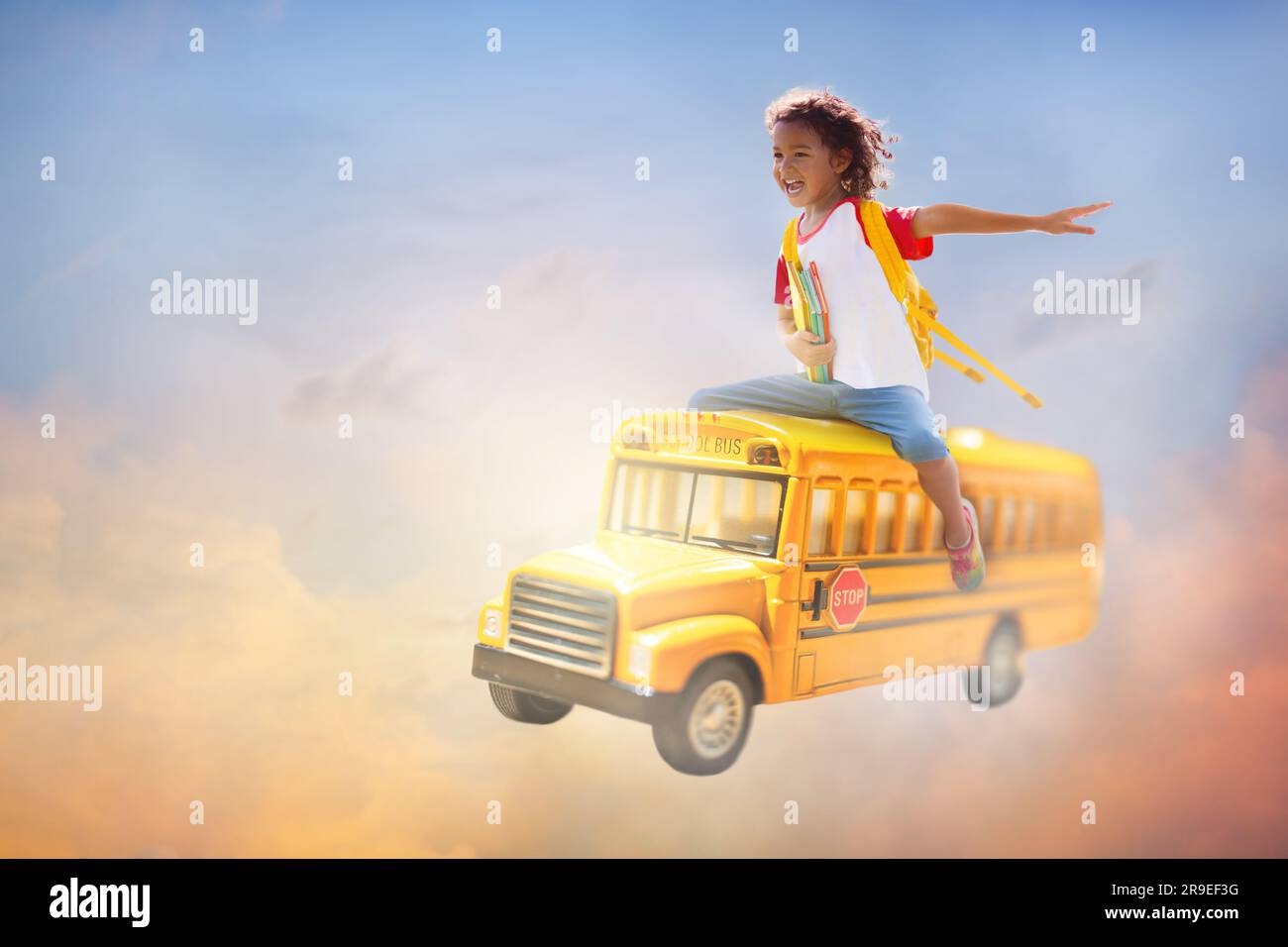 Child going back to school. Boy flying on school bus. Imagination and ...