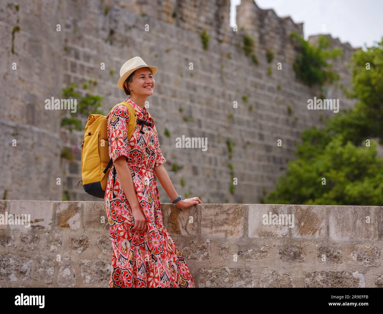 summer trip to Rhodes island, Greece. Young Asian woman in ethnic red ...