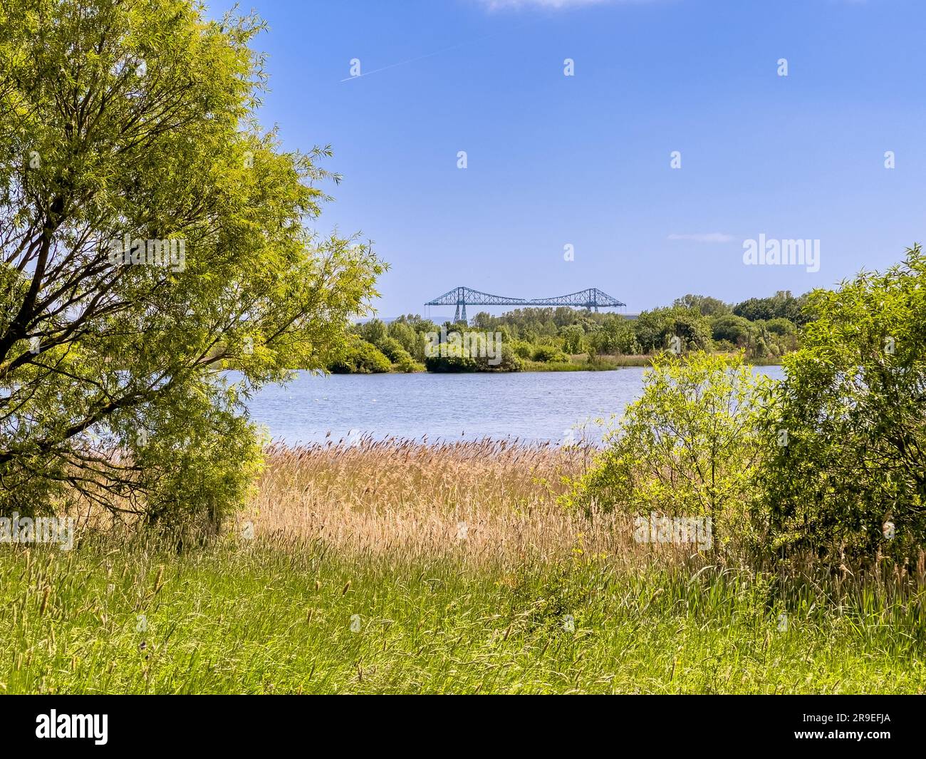 The lake at Saltholme nature reserve with the Middlesbrough Transporter ...