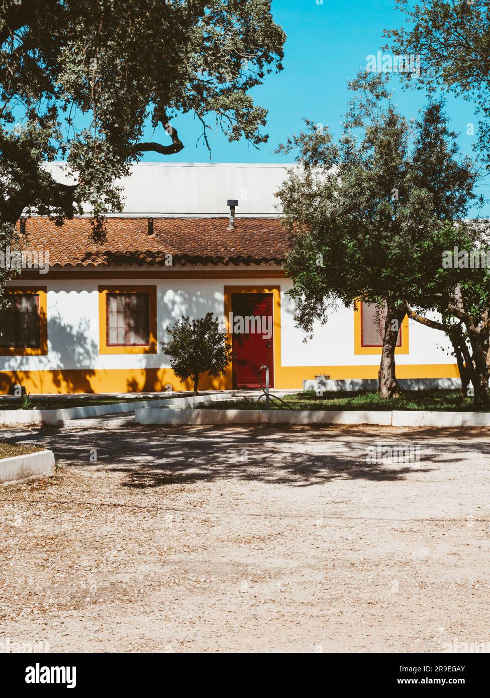 Traditional stone Portuguese house with tree planted yard. Single story ...