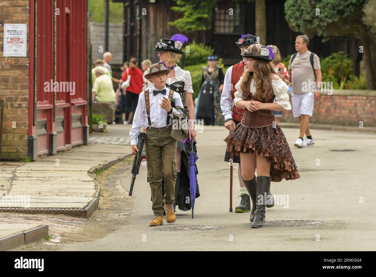 Steampunk family walking down the street hi-res stock photography and ...