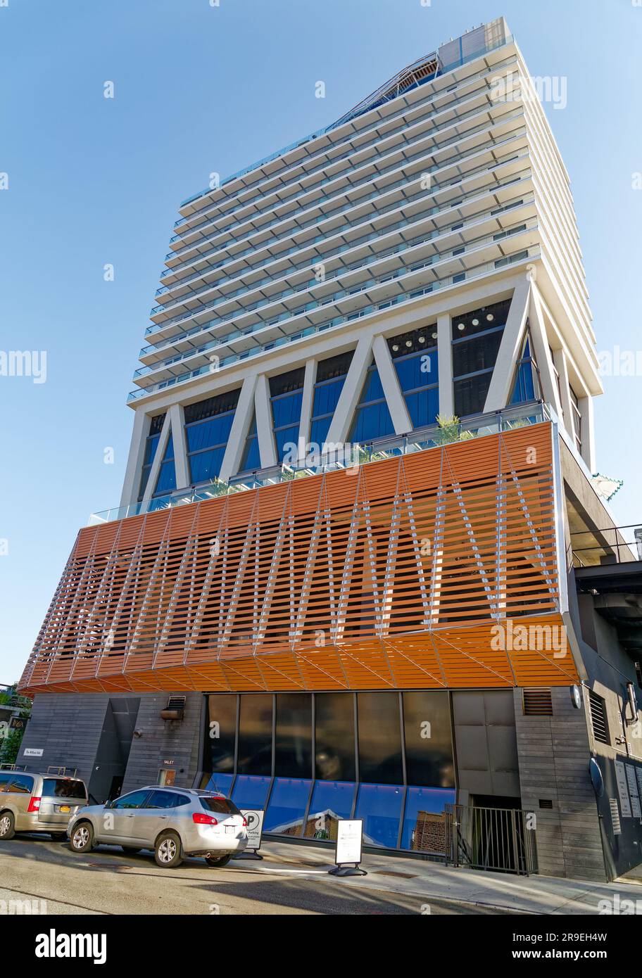 The William Vale hotel rises over truss-enclosed office floors, which ...