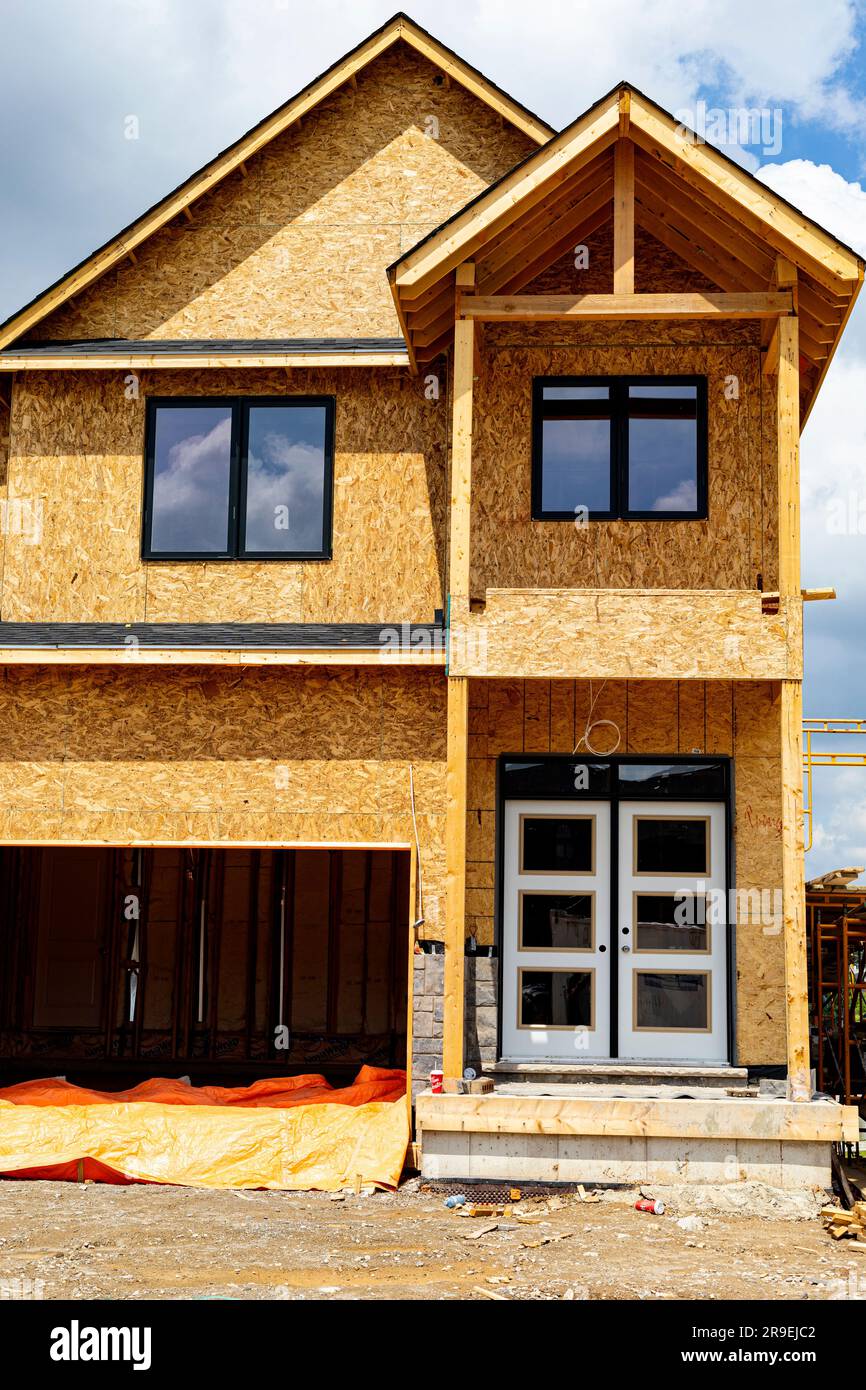 Exterior of framed residential house under construction in a ...