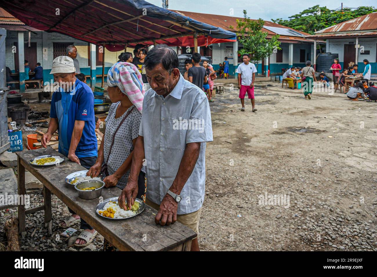 Churachandpur, India. 21st June, 2023. Displaced people take food at a ...