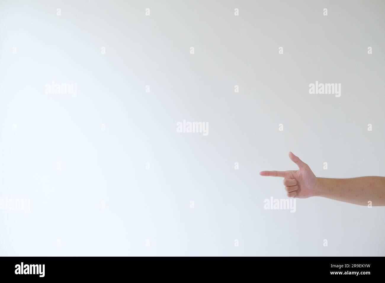 A hand on the right side is pointing to the left side. Isolated white ...