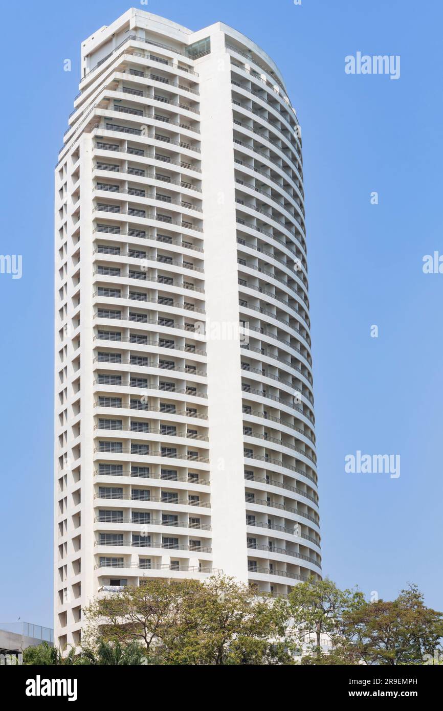 White high-rise building against blue sky, skyscraper. Identical high ...