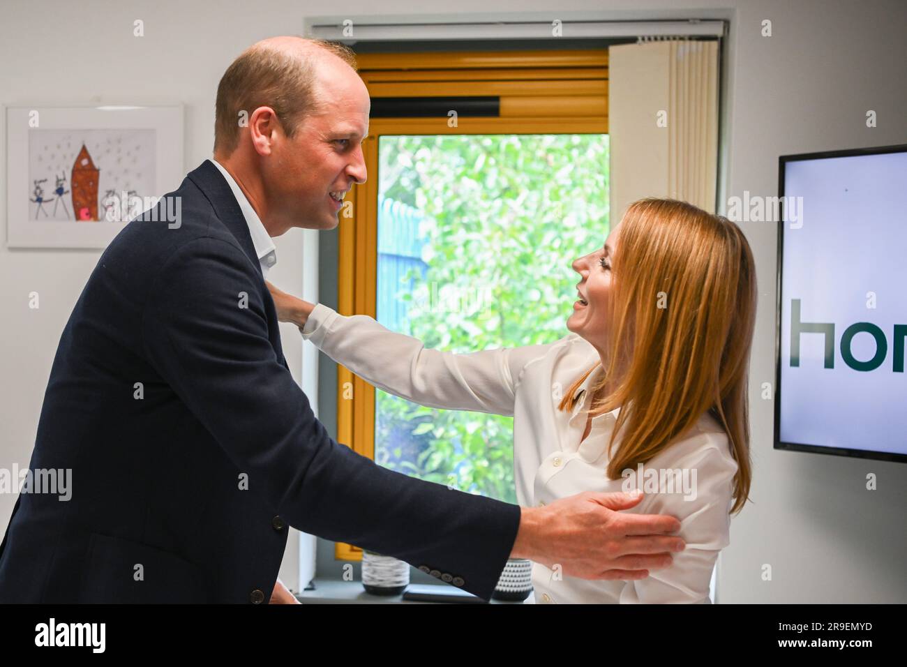 The Prince of Wales greets Geri Horner during a visit to Maindee ...