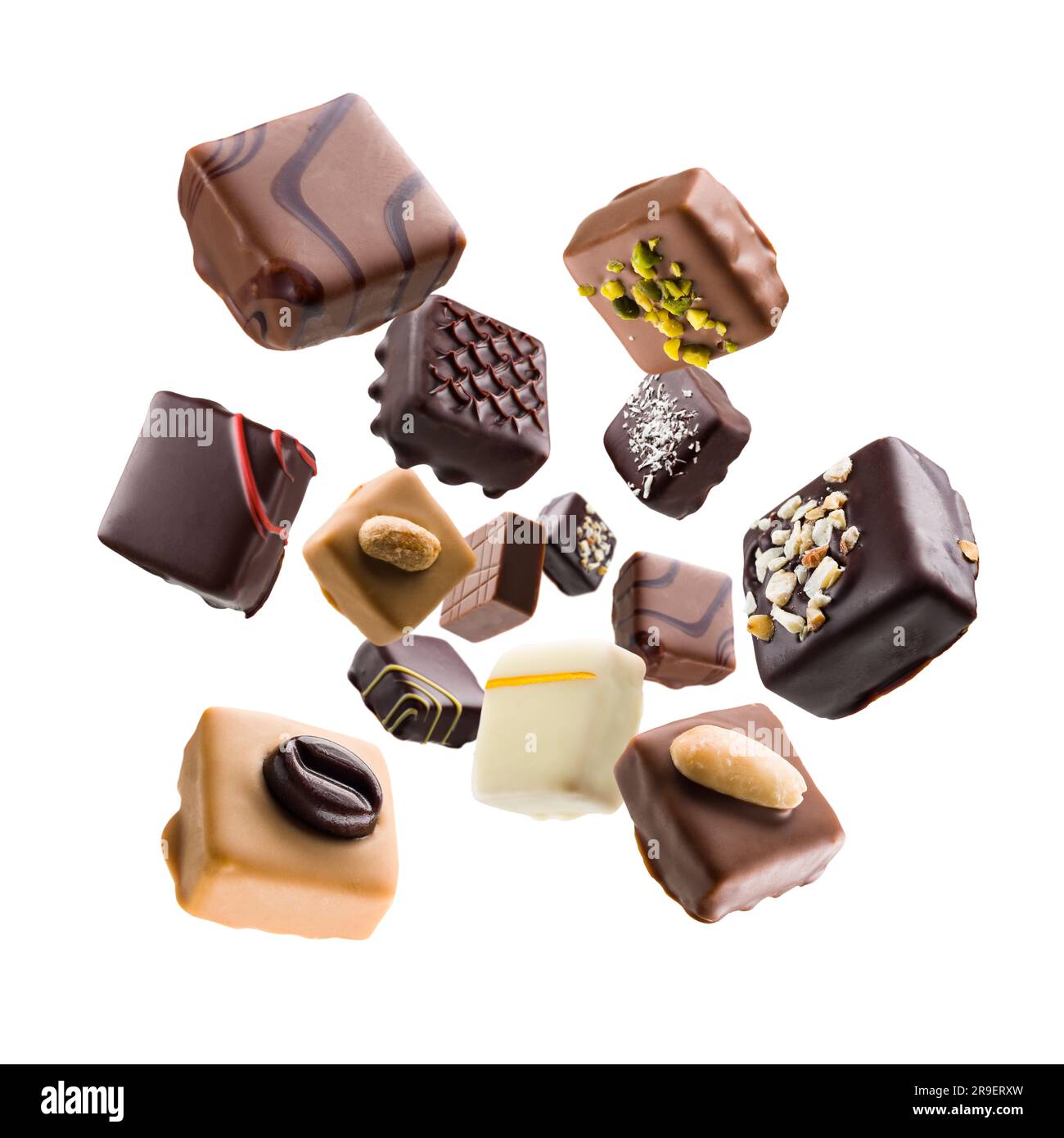 Assorted chocolate pralines falling on white background Stock Photo - Alamy