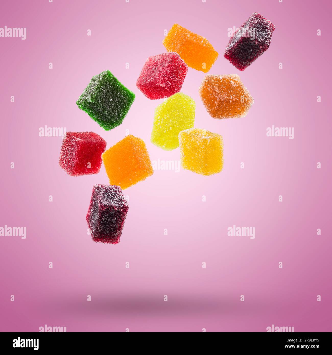 assorted jelly candies floating on colored background Stock Photo - Alamy