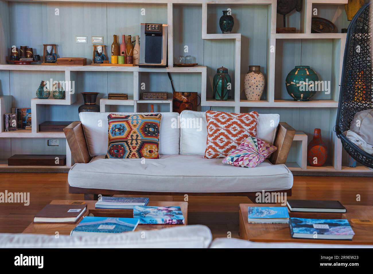 Luxury living room with antique pots and books on shelf Stock Photo - Alamy