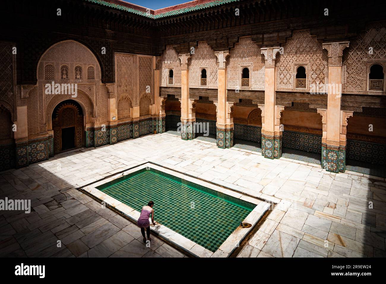 Inner courtyard of the Madrasa, there are arches and porticoes above ...