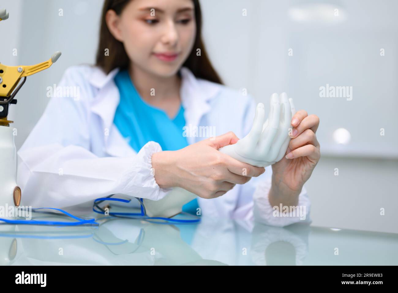 Technician testing robotic bionic arm at prosthetic manufacturing Stock ...