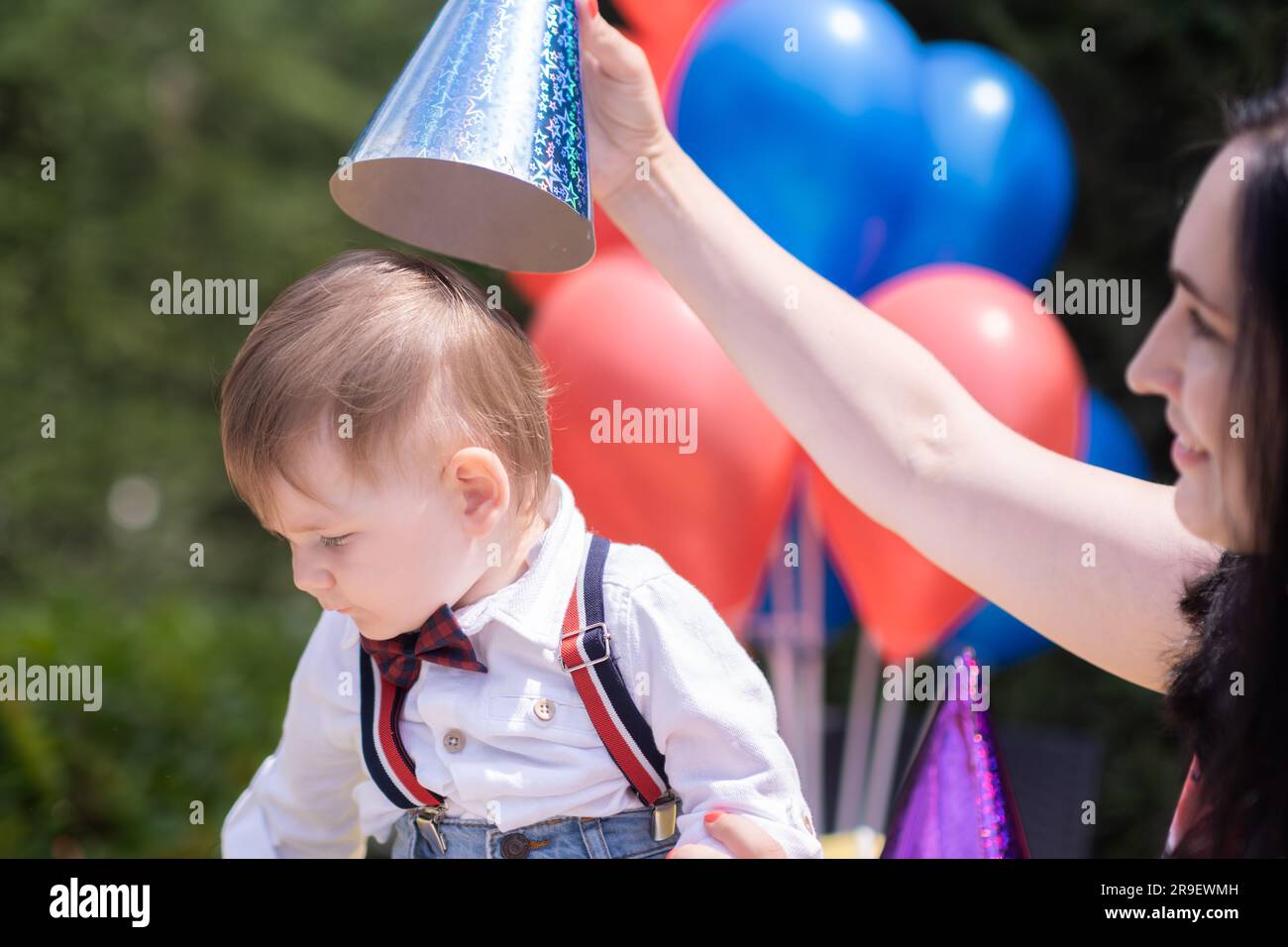 charming young boy, wearing suspenders, and his mom create a memorable ...