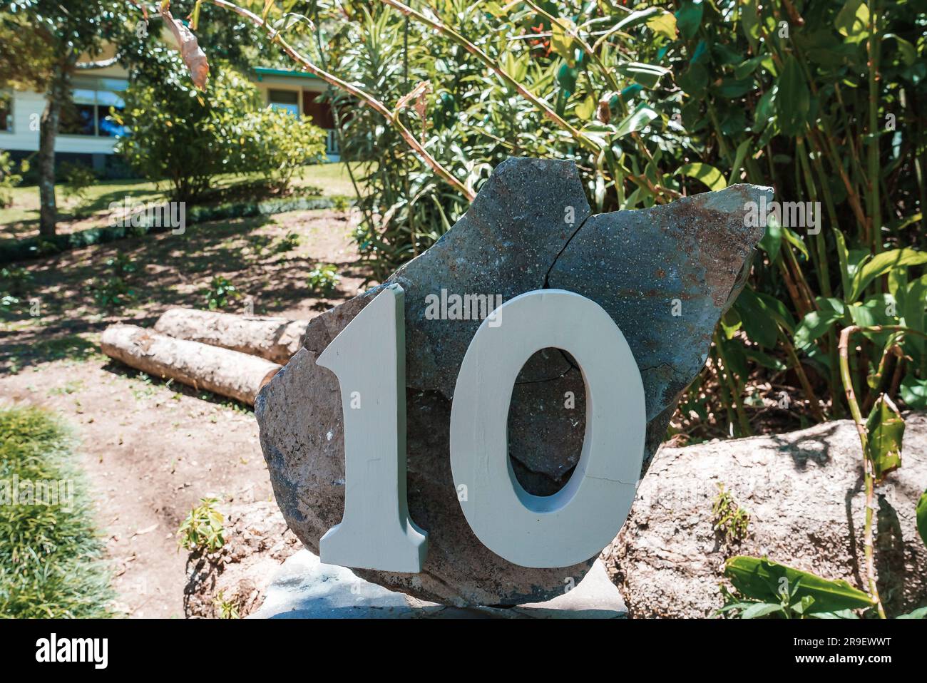 House number 10 installed on a big rock in the garden of residence ...