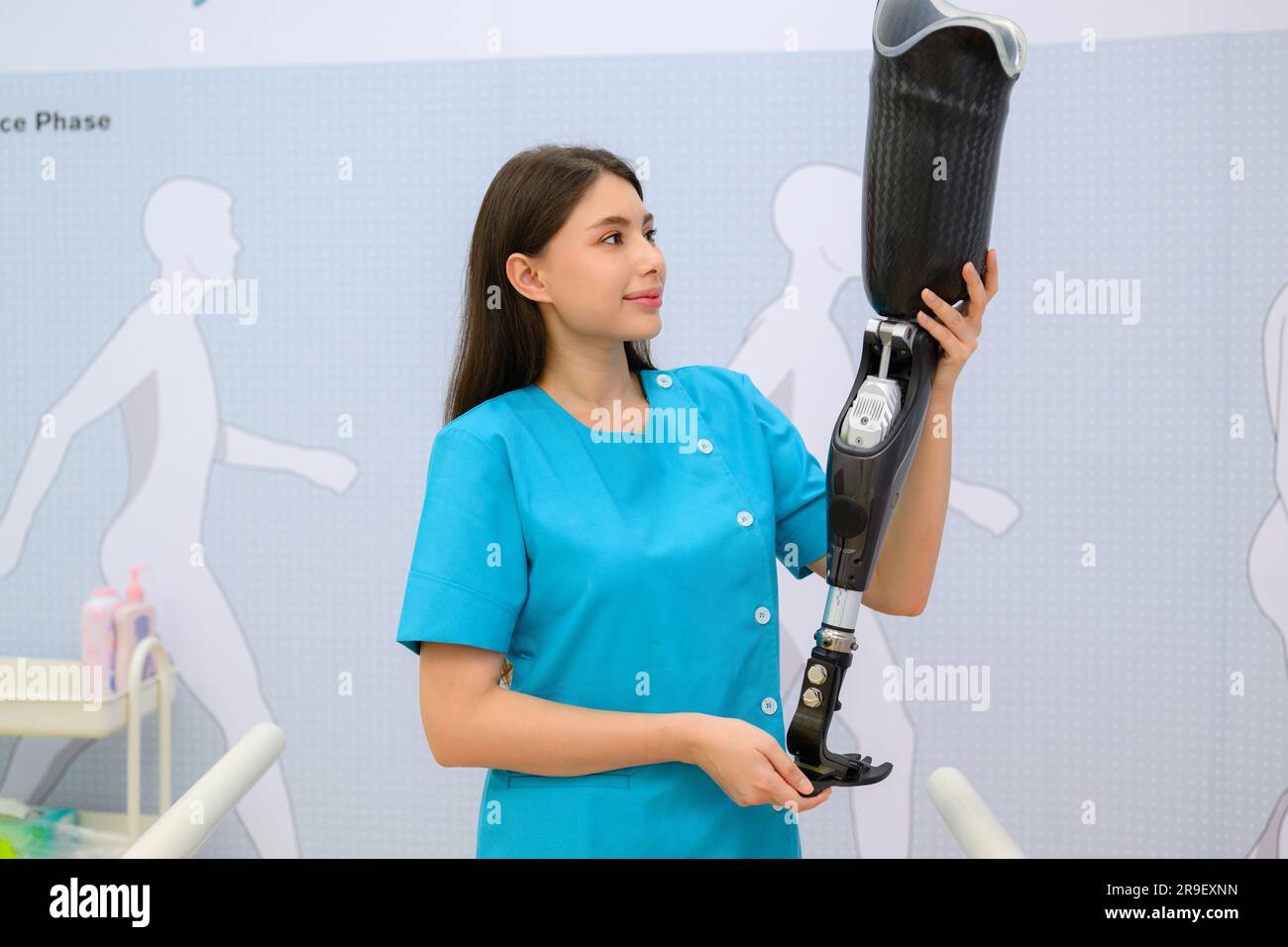 Female technician holding prosthetic limb checking in medical clinic ...