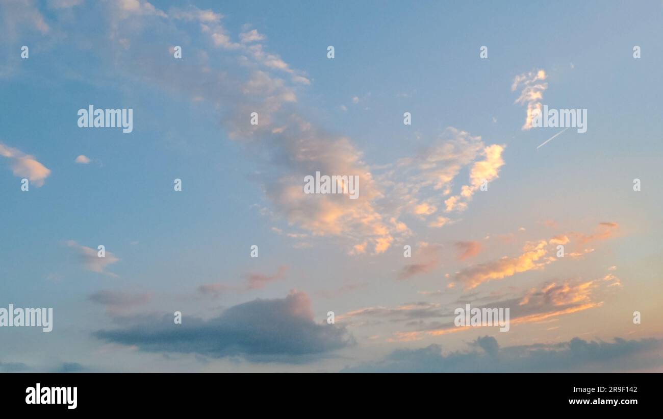 A vivid summer background of sunset sky at evening with hues of fiery ...