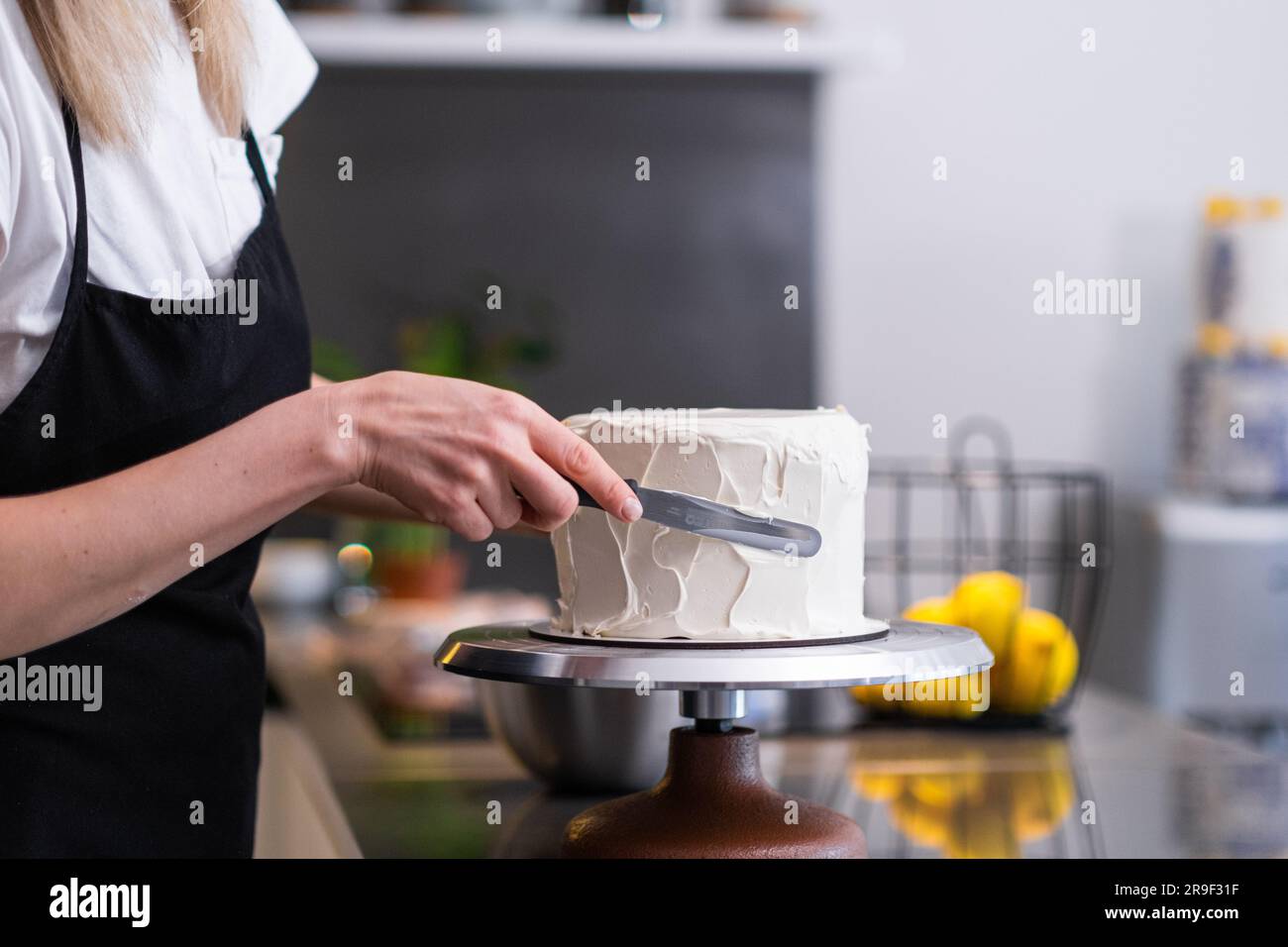 Professional confectioner spreading white sugar free mastic around ...