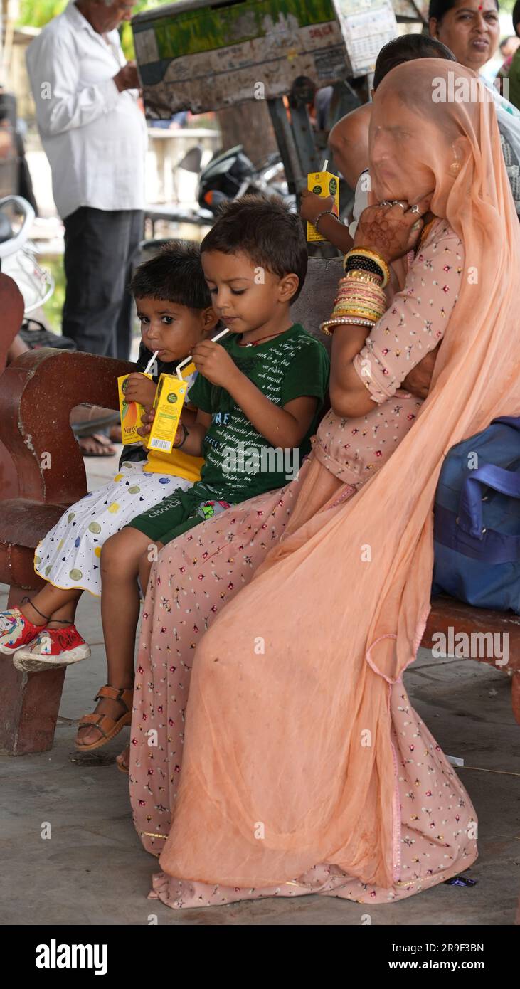 Beawar, India, June 25, 2023: Rajasthani woman with her children waits ...