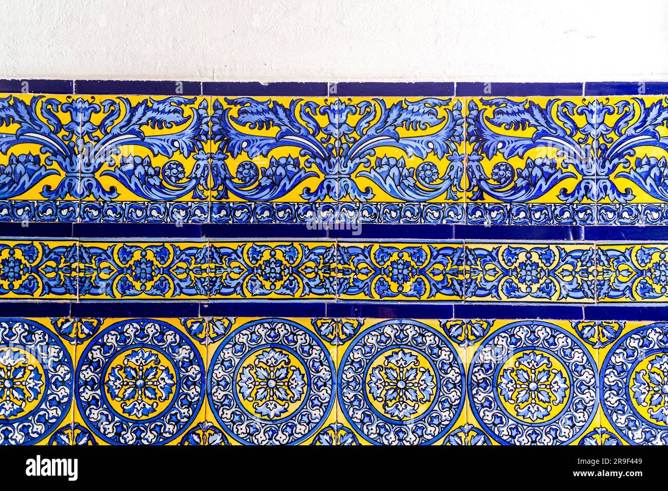 Fragment of Andalusian glazed ceramic tiled wall close up texture ...