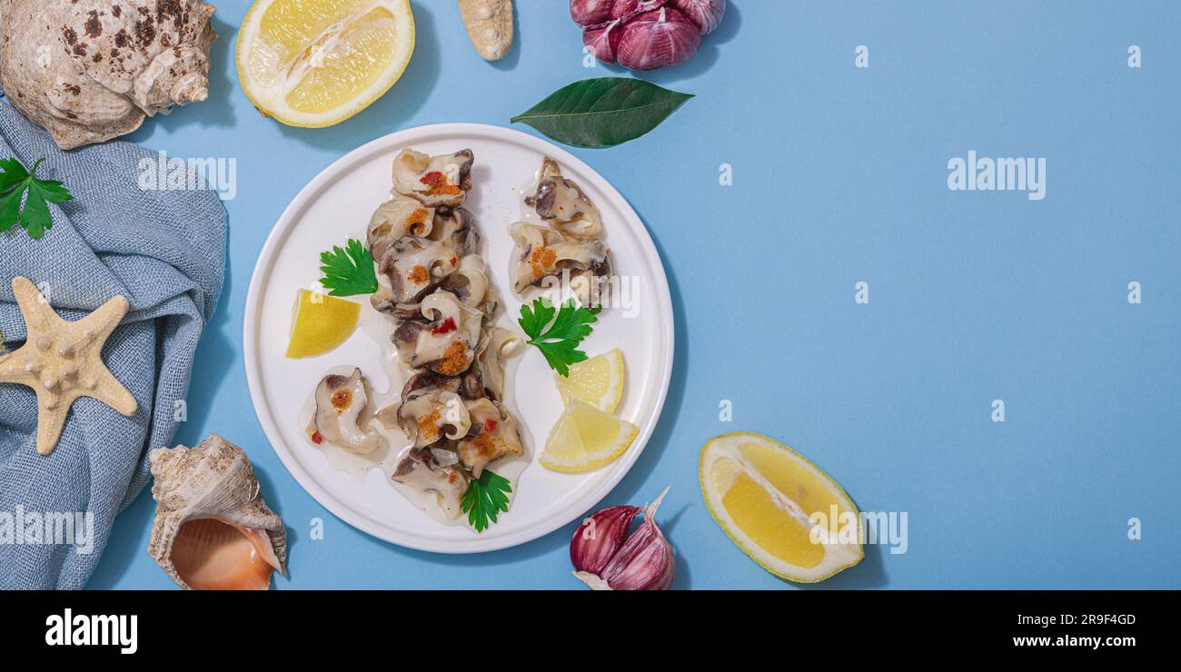 Pickled rapan meat with oil, spices and greens. Healthy seafood rich of ...