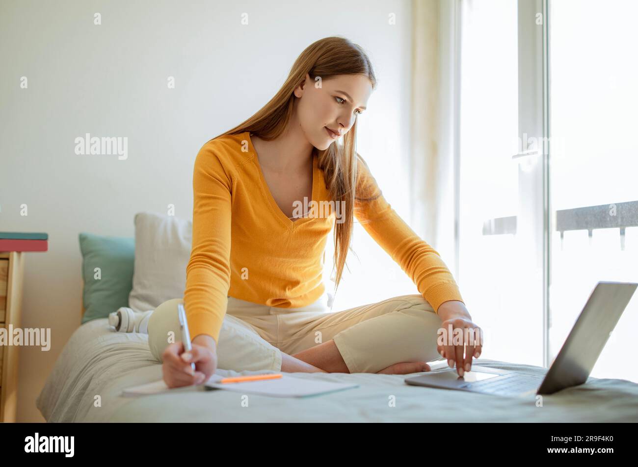 Young Student Lady At Laptop Learning Taking Notes At Home Stock Photo ...