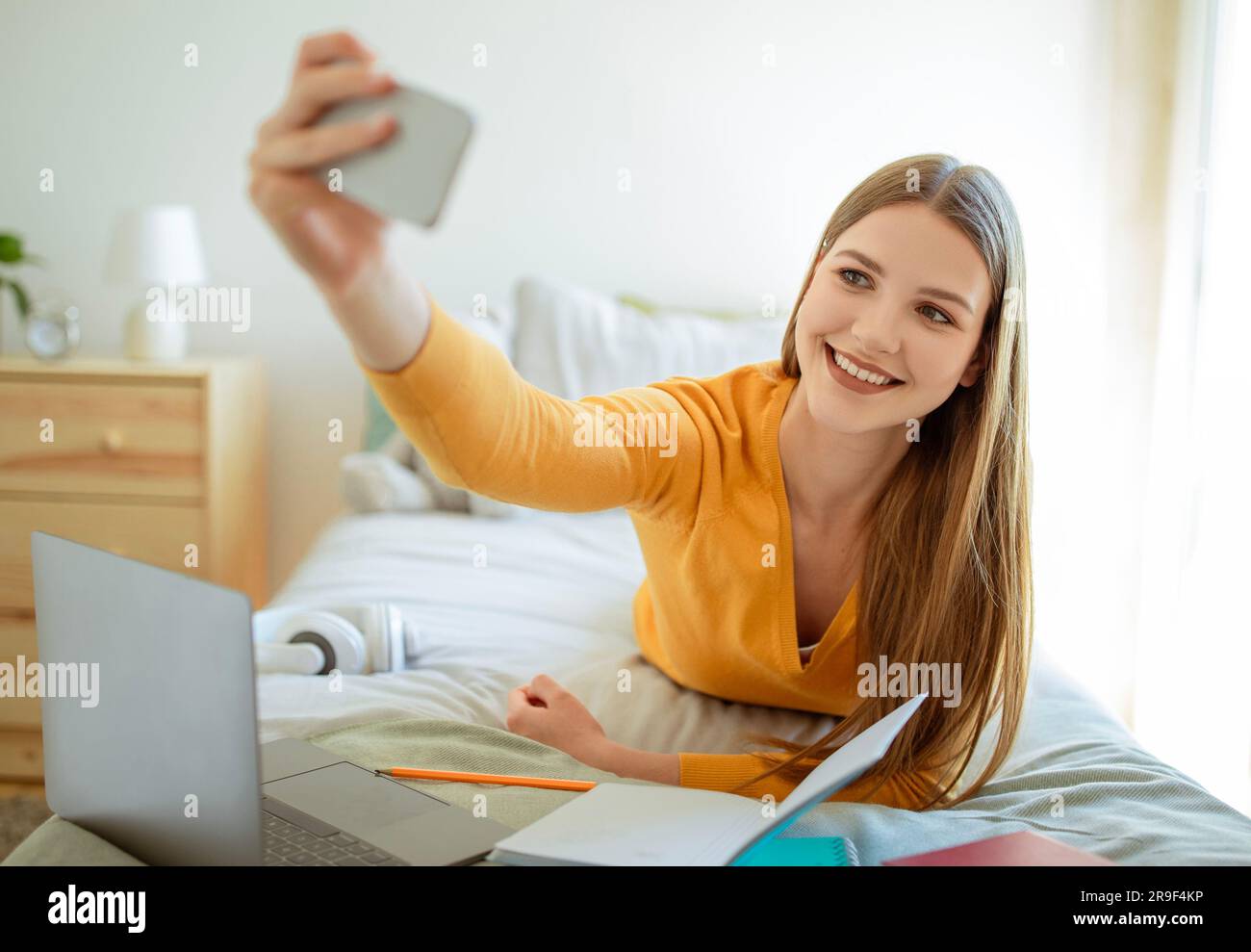 Student Lady Learning At Laptop And Making Selfie In Bedroom Stock ...