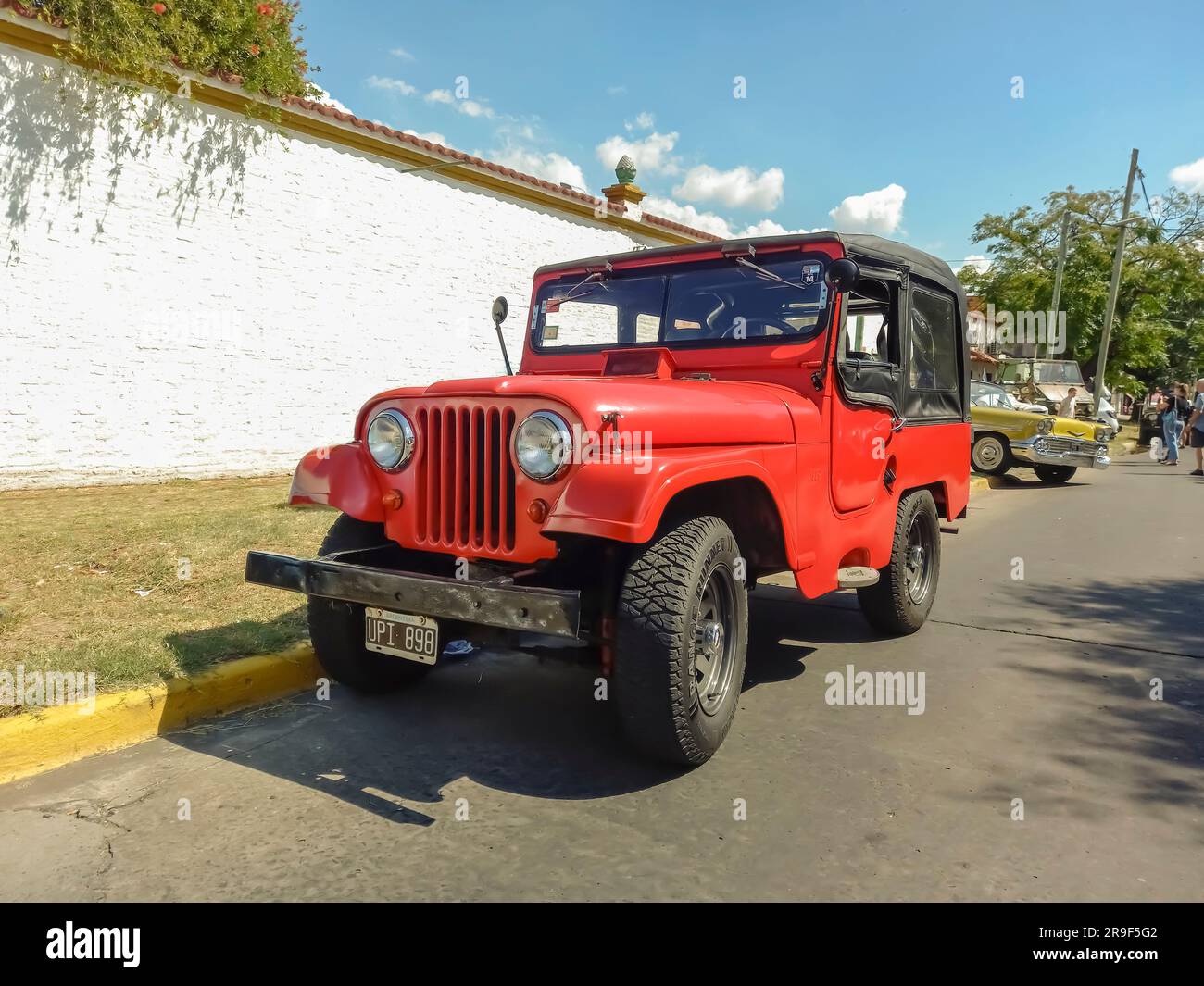 Old red off-road Jeep Willys CJ 4x4 1960s in the street. CADEAA 2023 ...