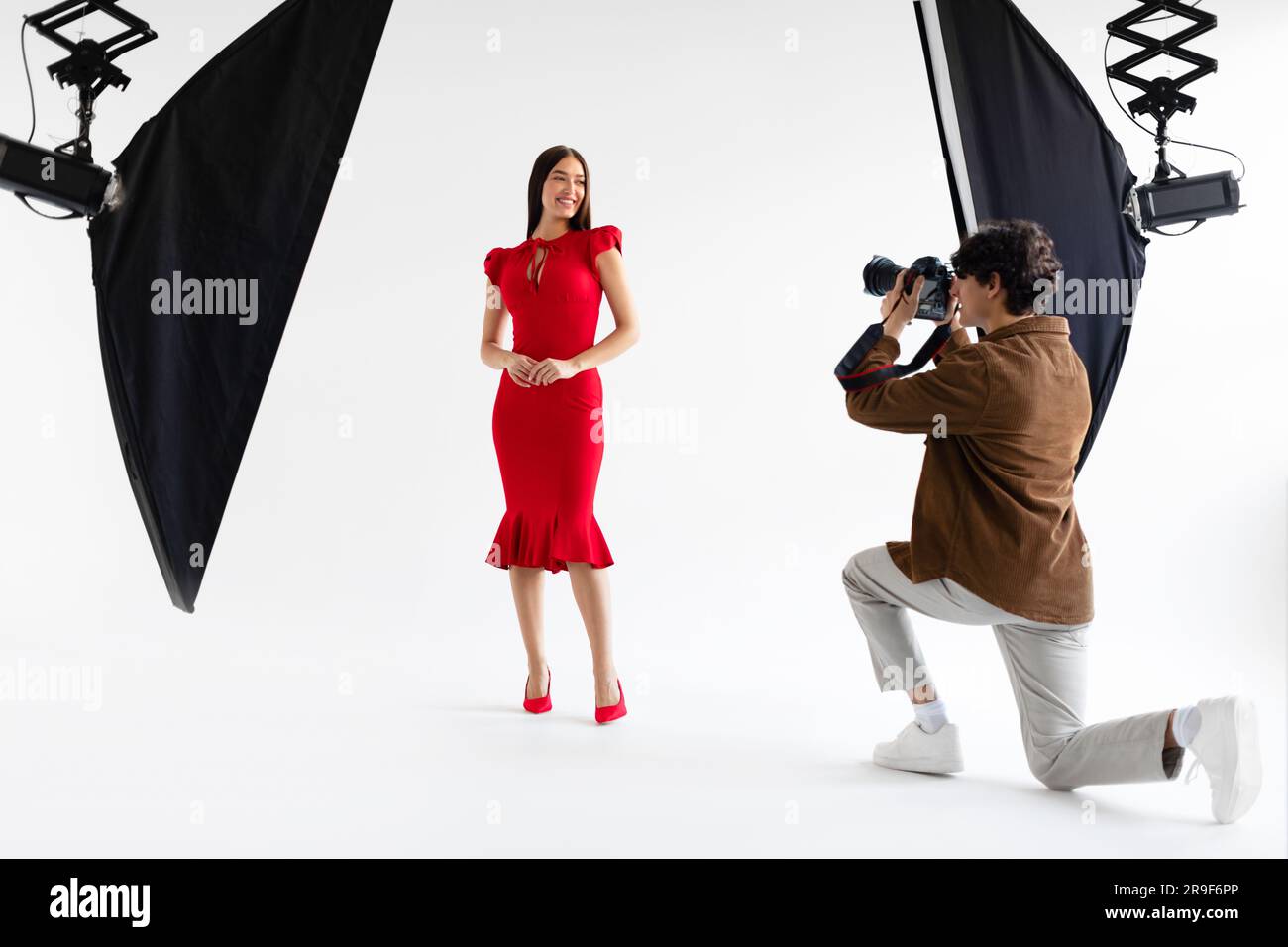 Fashion photoshoot. Professional photographer taking photos of female ...