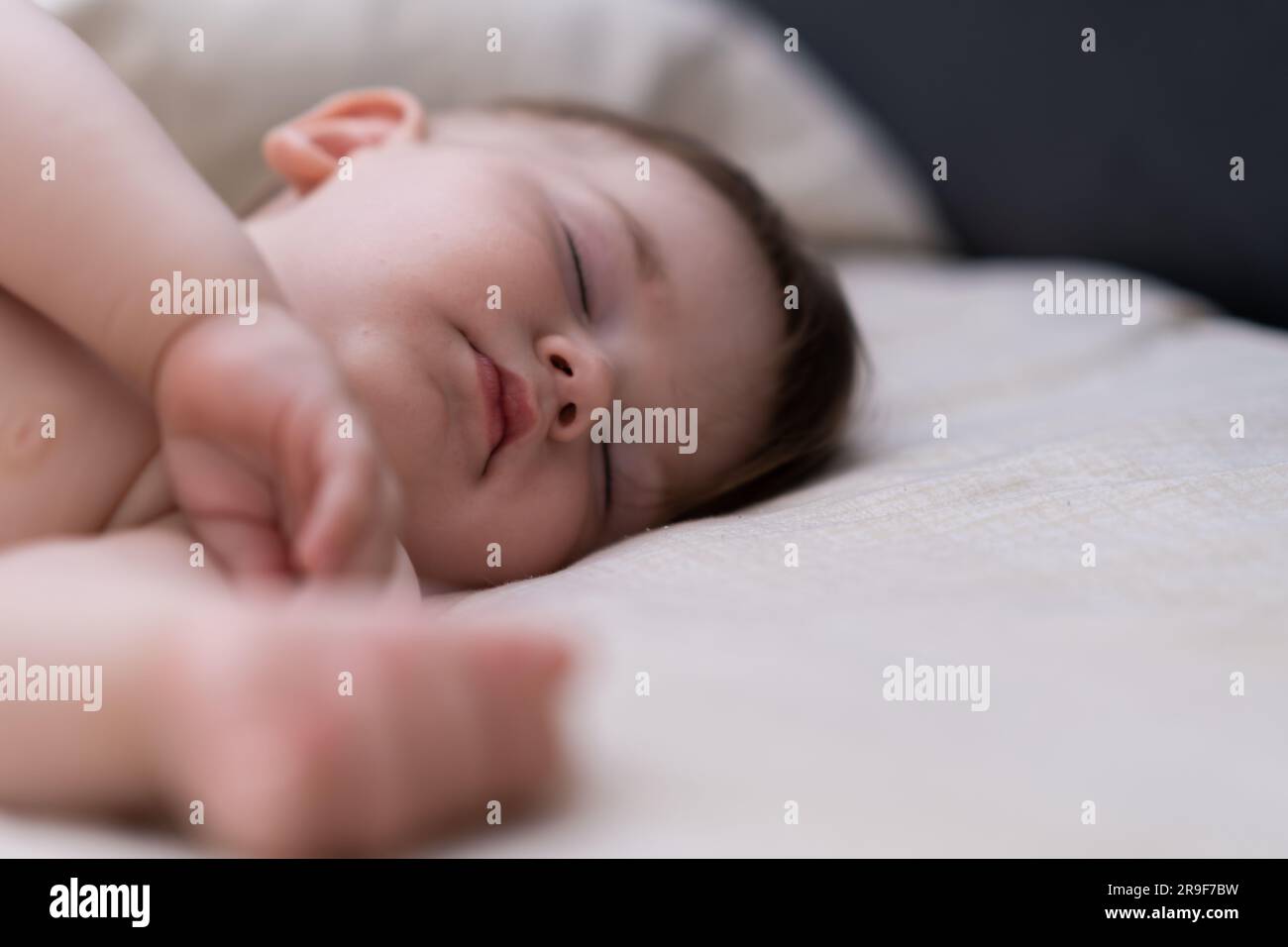Cute chubby baby sleeping on soft bed with white sheet after ...