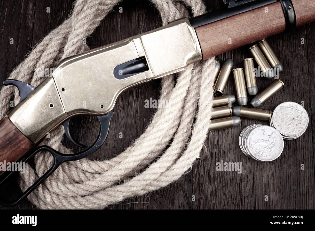 Old west guns. Lever-action repeating rifles with ammunition on wooden ...